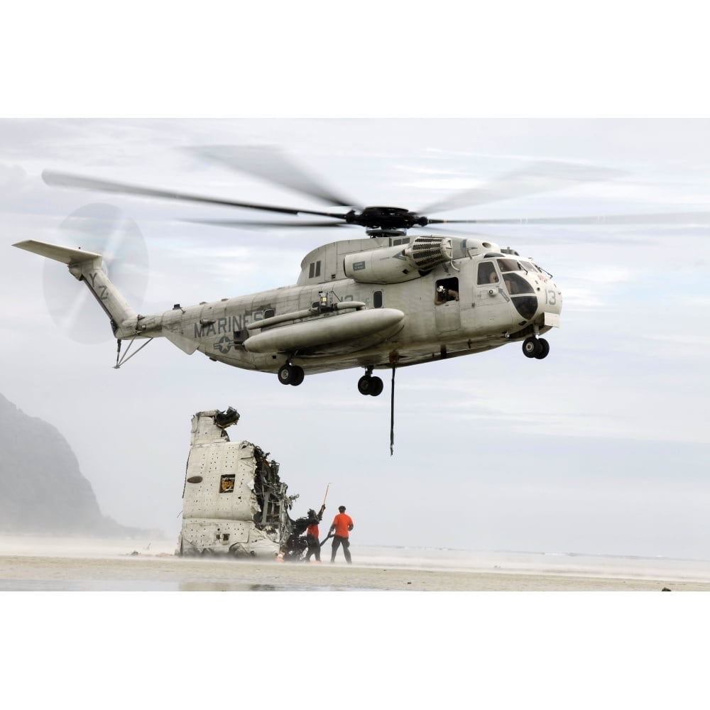 U.S. Sailors assist a CH-53D Sea Stallion helicopter in removing ...