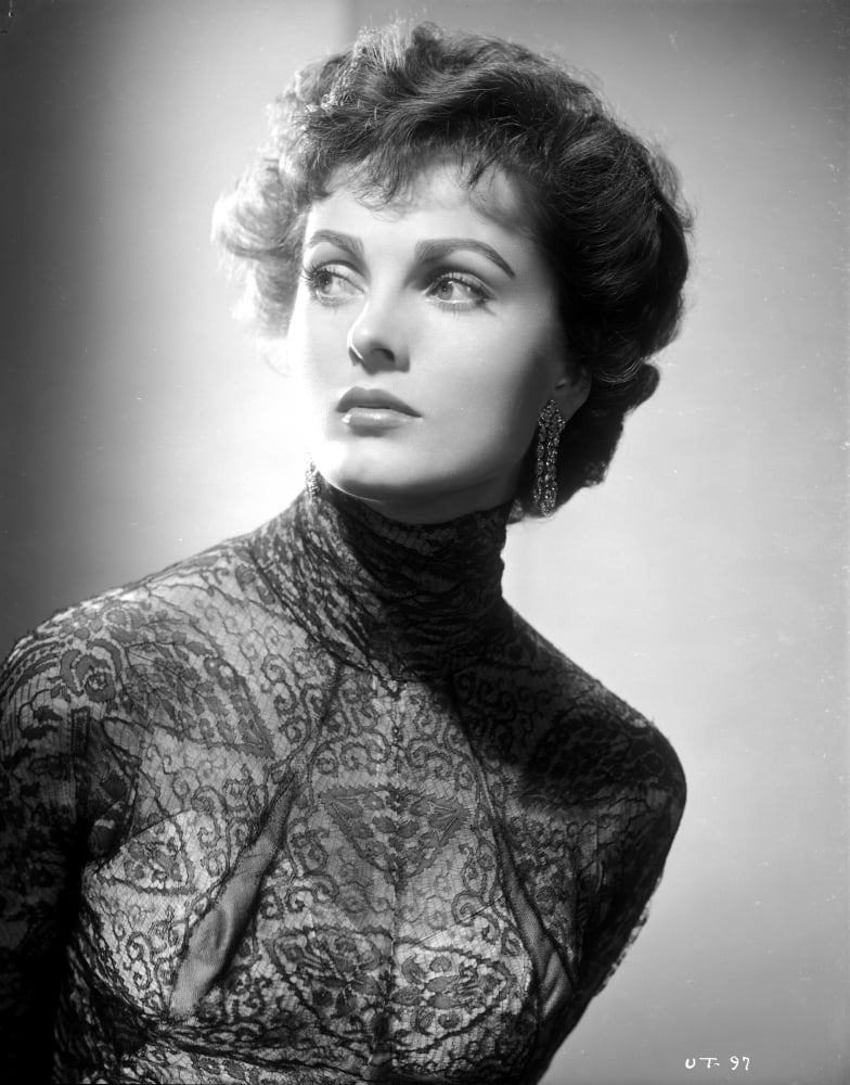 Ursula Theiss peering away from the camera, wearing a long-sleeve ...