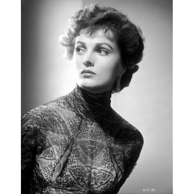Ursula Theiss peering away from the camera, wearing a long-sleeve ...