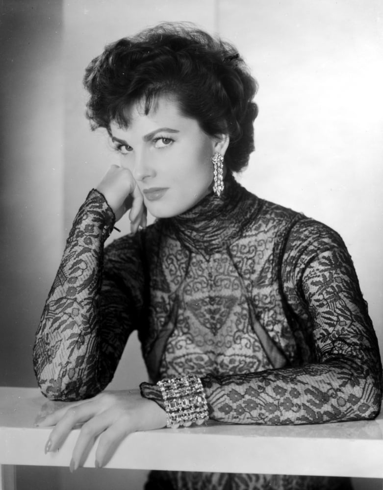 Ursula Theiss posed with her arm propped onto a tabletop, leaning her ...