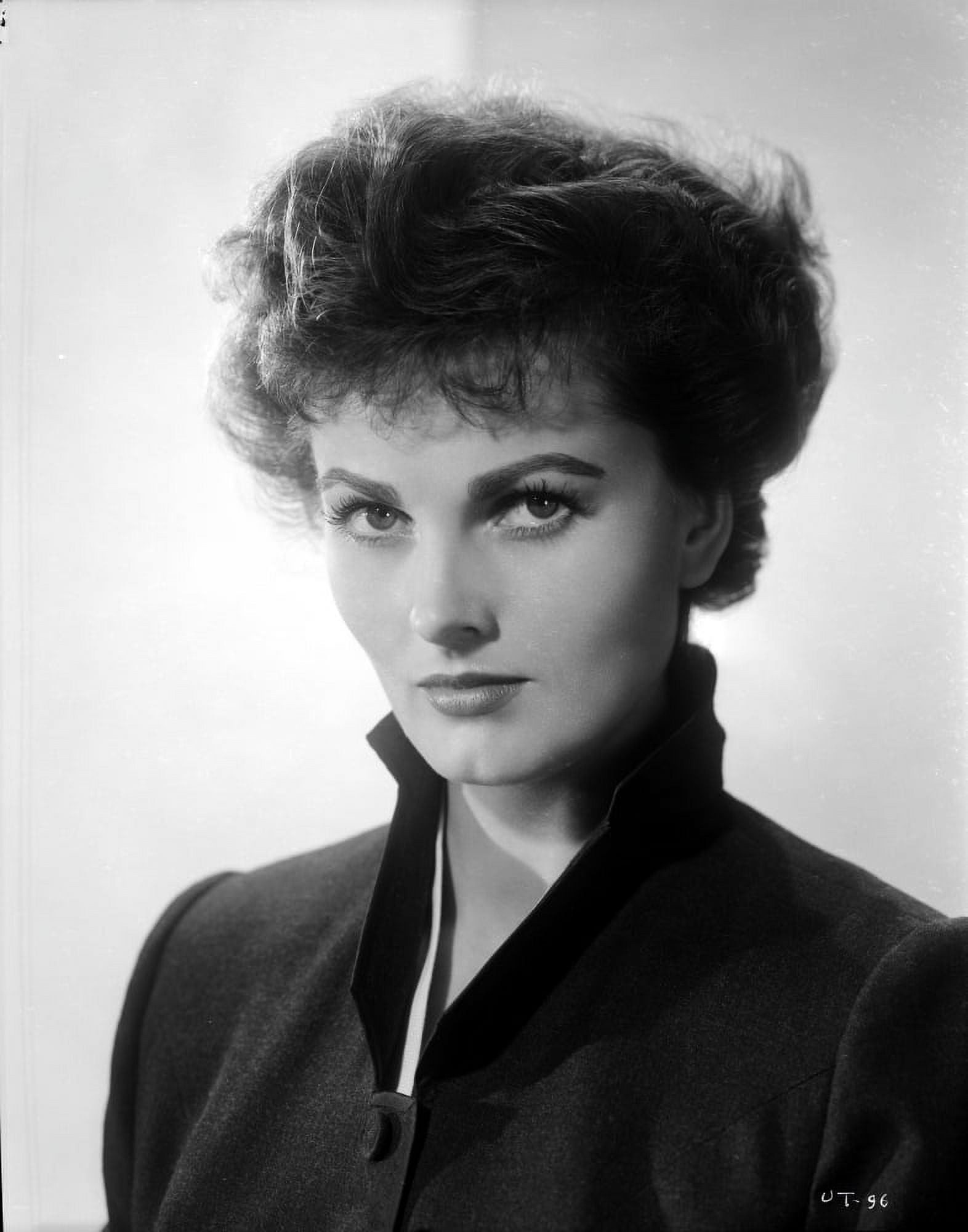 Ursula Theiss staring intently into the camera, wearing a high-neck ...