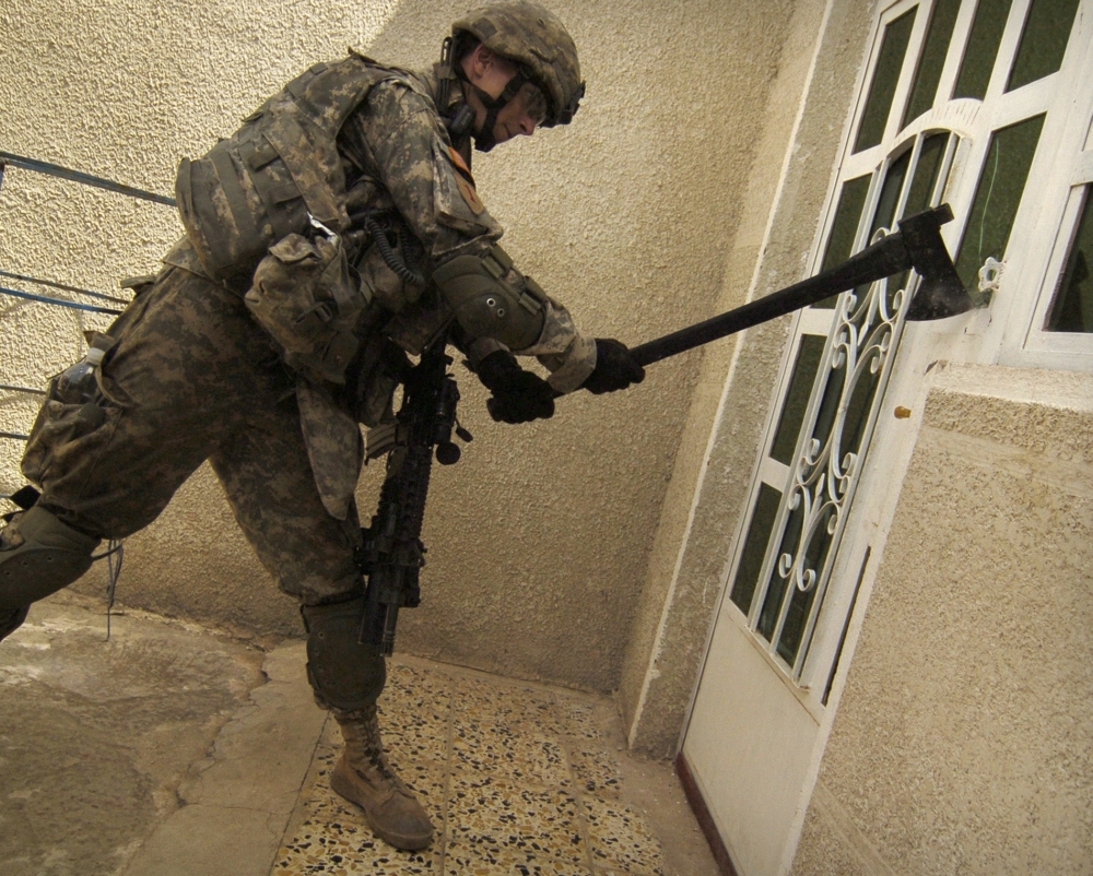 Us Soldier Breaks Down A Door During A House-To-House Search For ...