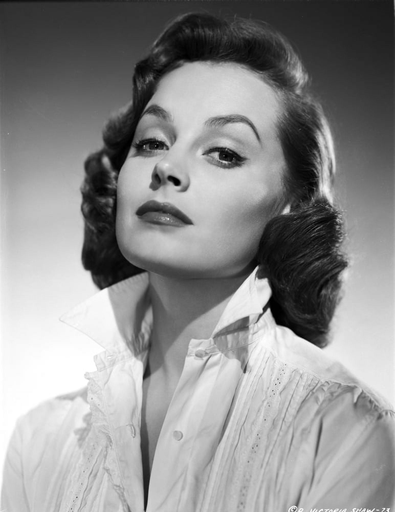 Victoria Shaw posed wearing a white, front ruffled pleated, button down ...