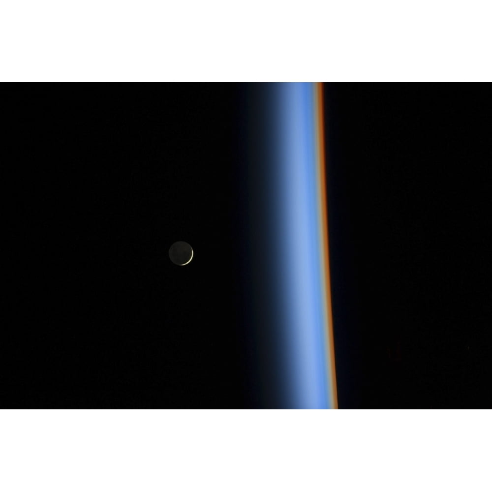 View of a crescent moon rising and the cusp of Earths atmosphere Poster ...