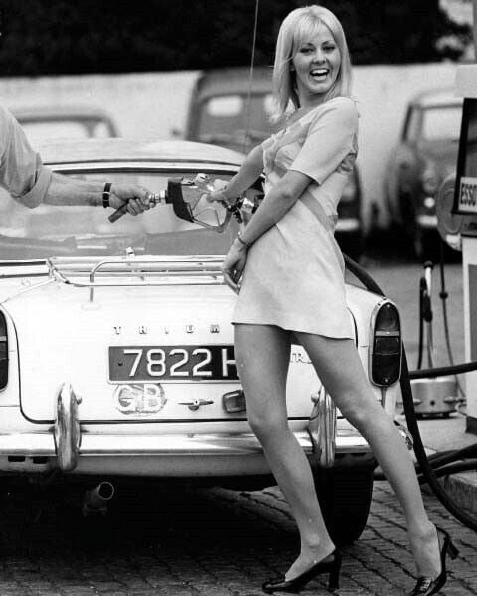 Yutte Stensgaard clowns with gas pump fueling her Triumph TR6 24x30 inch poster - Walmart.com