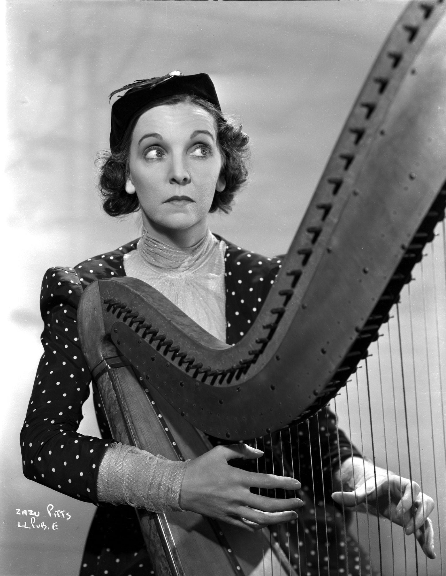 Zasu Pitts Looking Away while Playing a Harp in polka dot Dress Photo ...