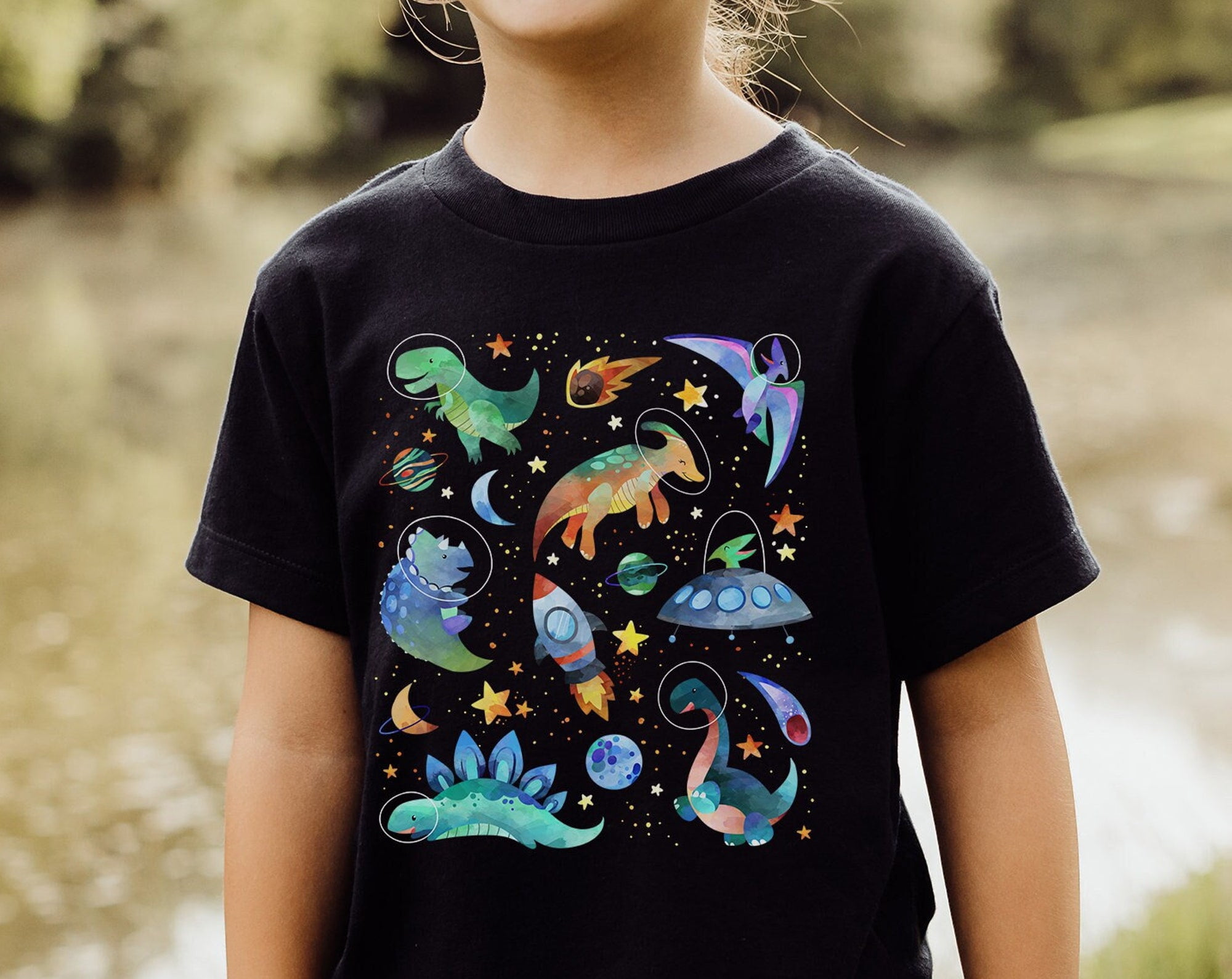 black tshirt with a colorful graphic print of dinosaurs planets stars ...