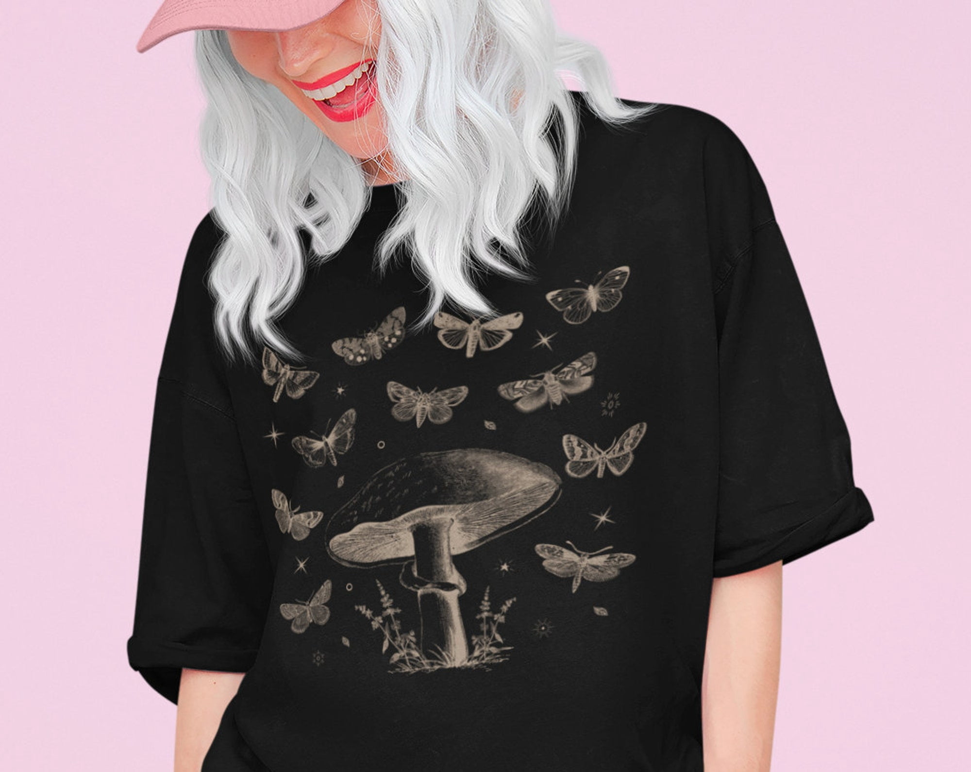 black tshirt with a graphic of a mushroom and butterflies The shirt is ...