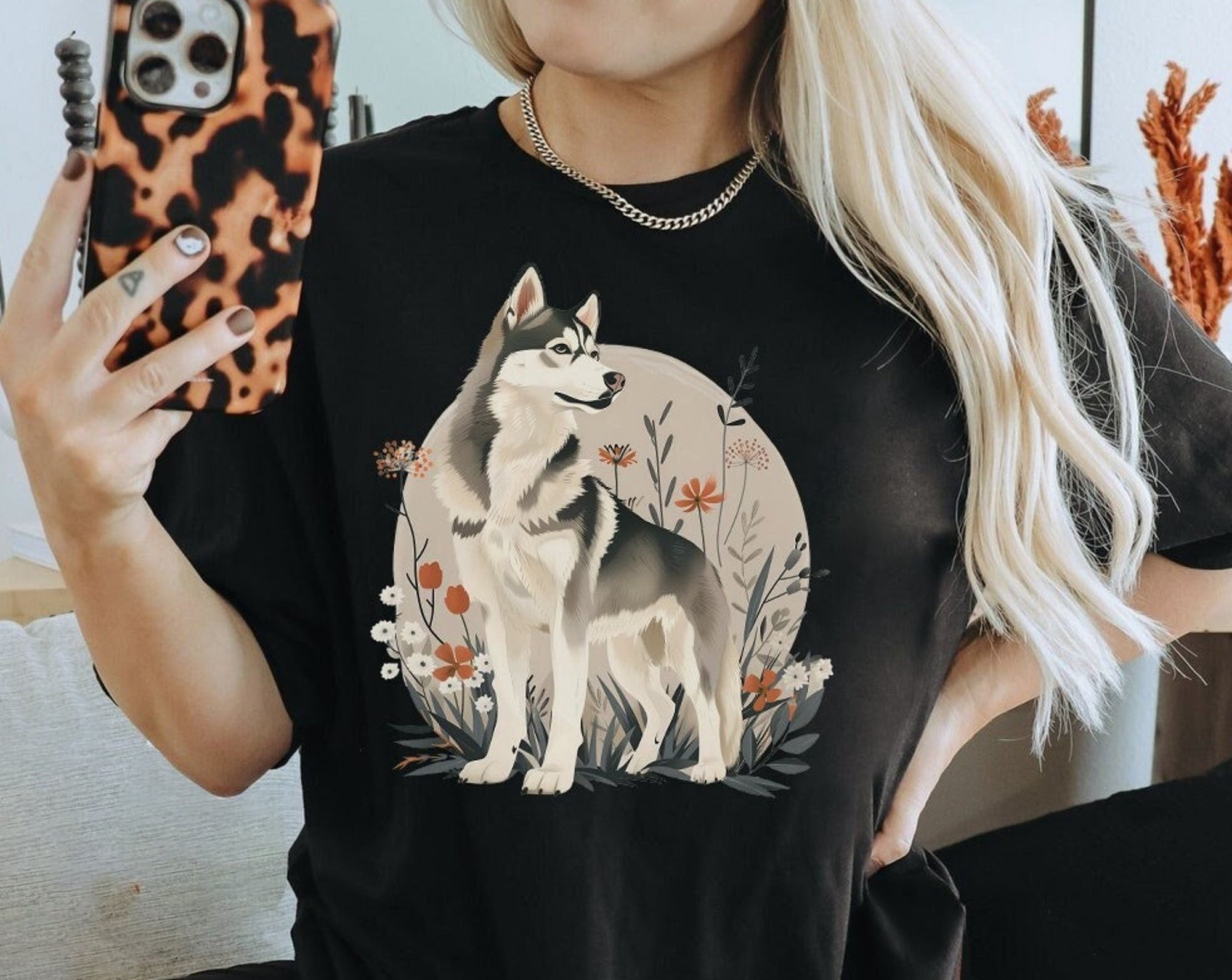 black tshirt with a graphic of a wolf standing in a field of flowers ...
