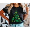 black tshirt with a green dinosaur Christmas tree design The tree is ...