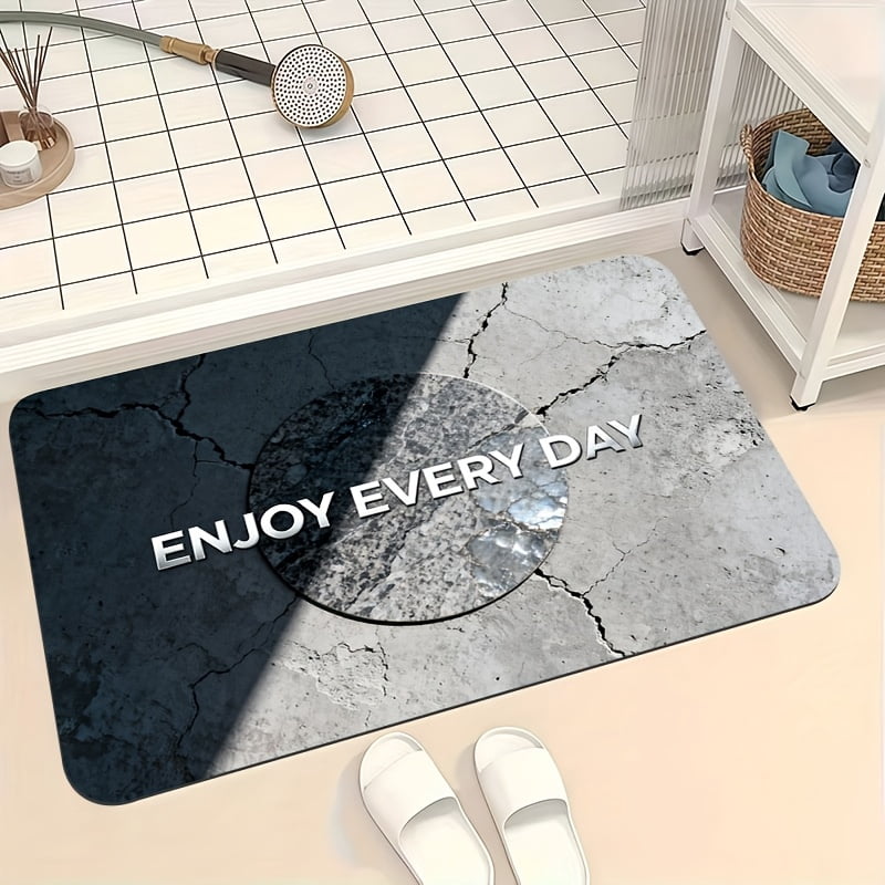 A black and white crackled floor mat made of highly absorbent ...