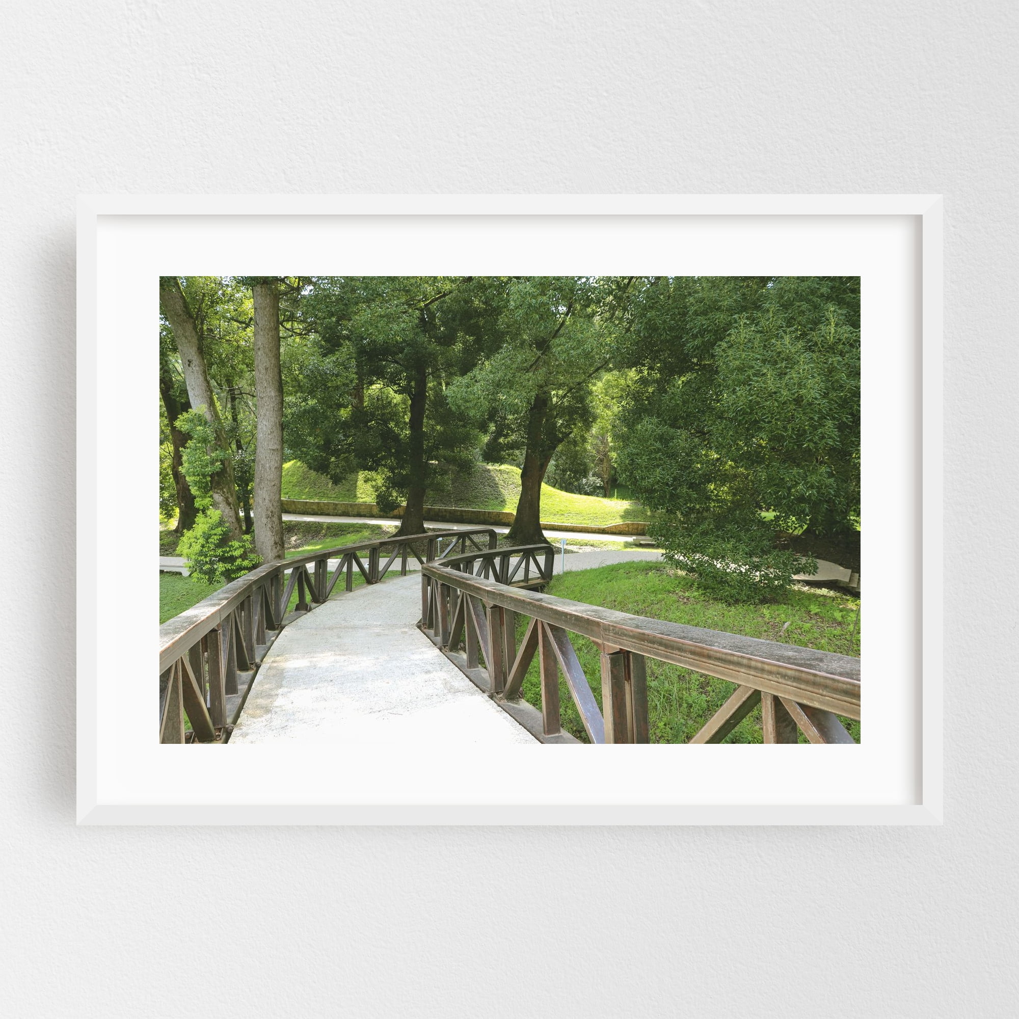 bridge with wooden railings in the park. Bridge among trees in the park ...