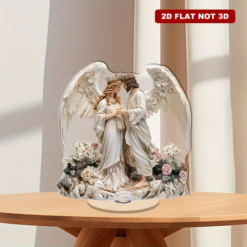 A rotating acrylic ornament featuring a vibrant angel couple in robes ...