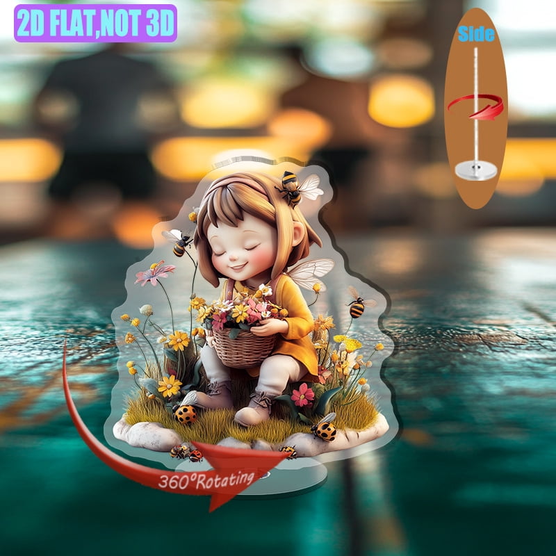 A rotating acrylic ornament featuring a whimsical figure in a meadow ...