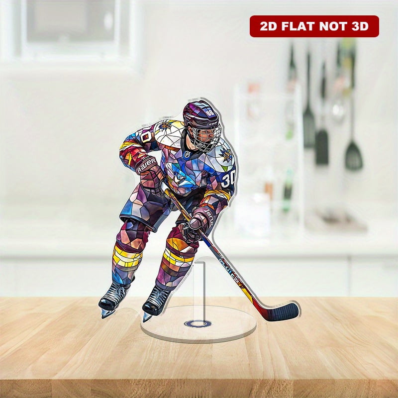 A rotating acrylic piece showcasing a hockey player shielding the puck ...