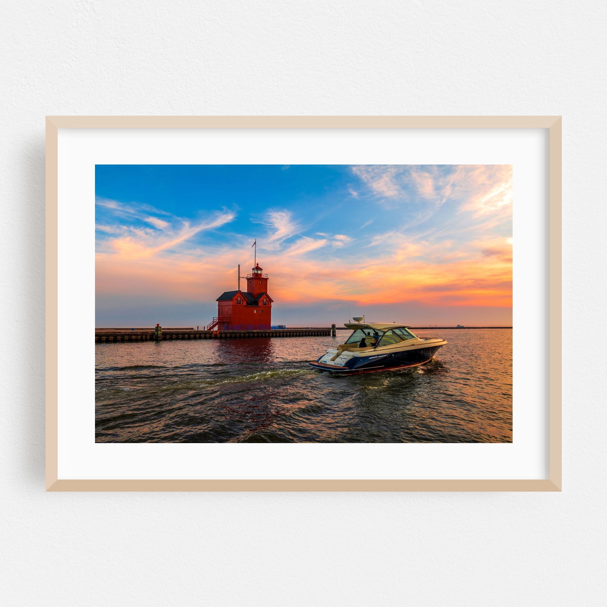 A serene sunset illuminates Big Red Lighthouse as a boat departs ...